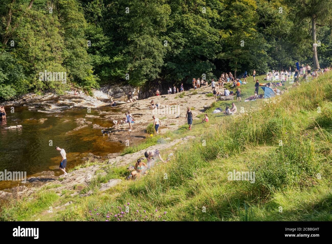 08.08.2020 Stainforth, North Yorkshire, UK. People sunbathing and ...