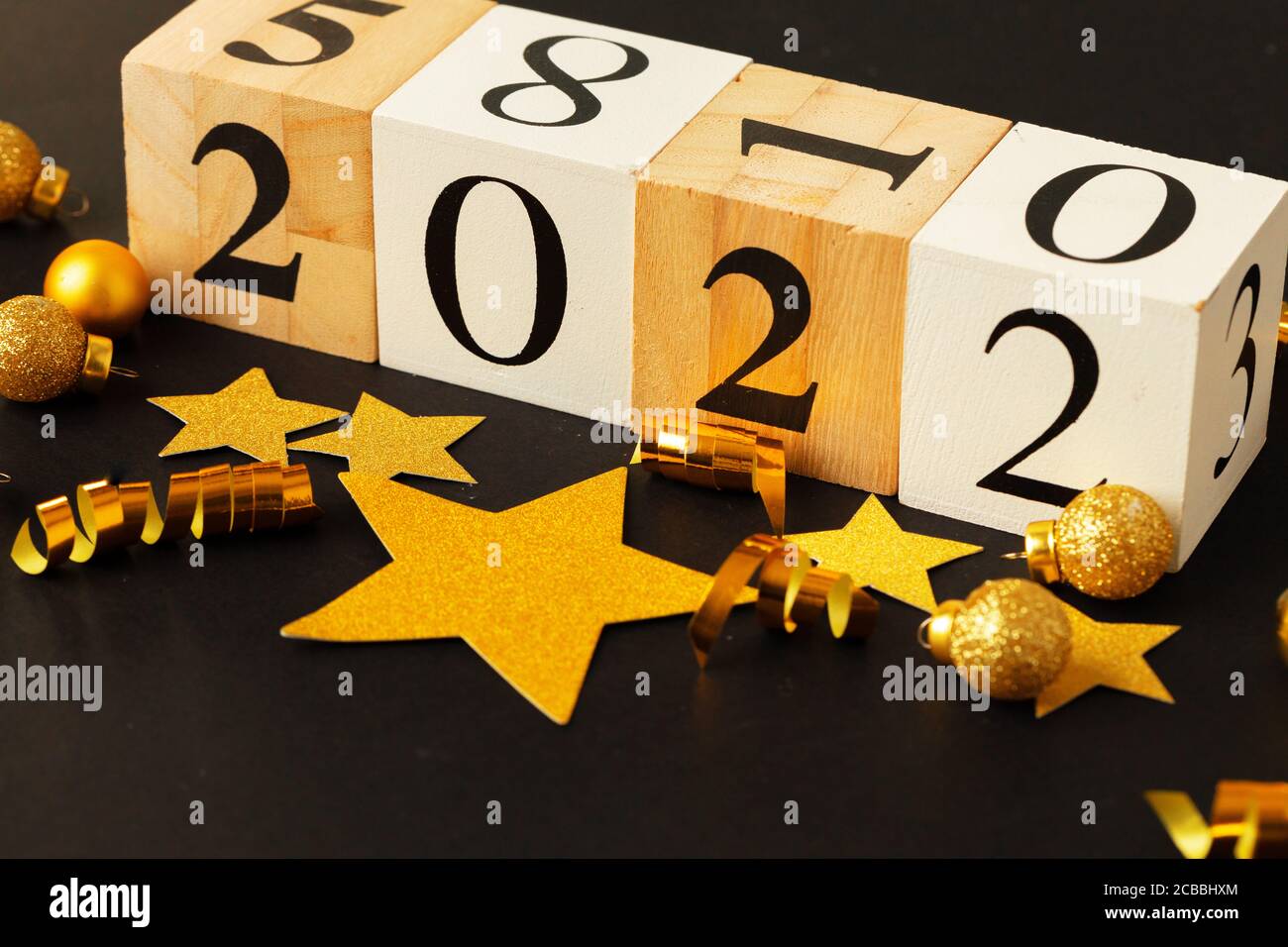 Concept of the year 2022. Golden stars and numbers 2022 on paper ...
