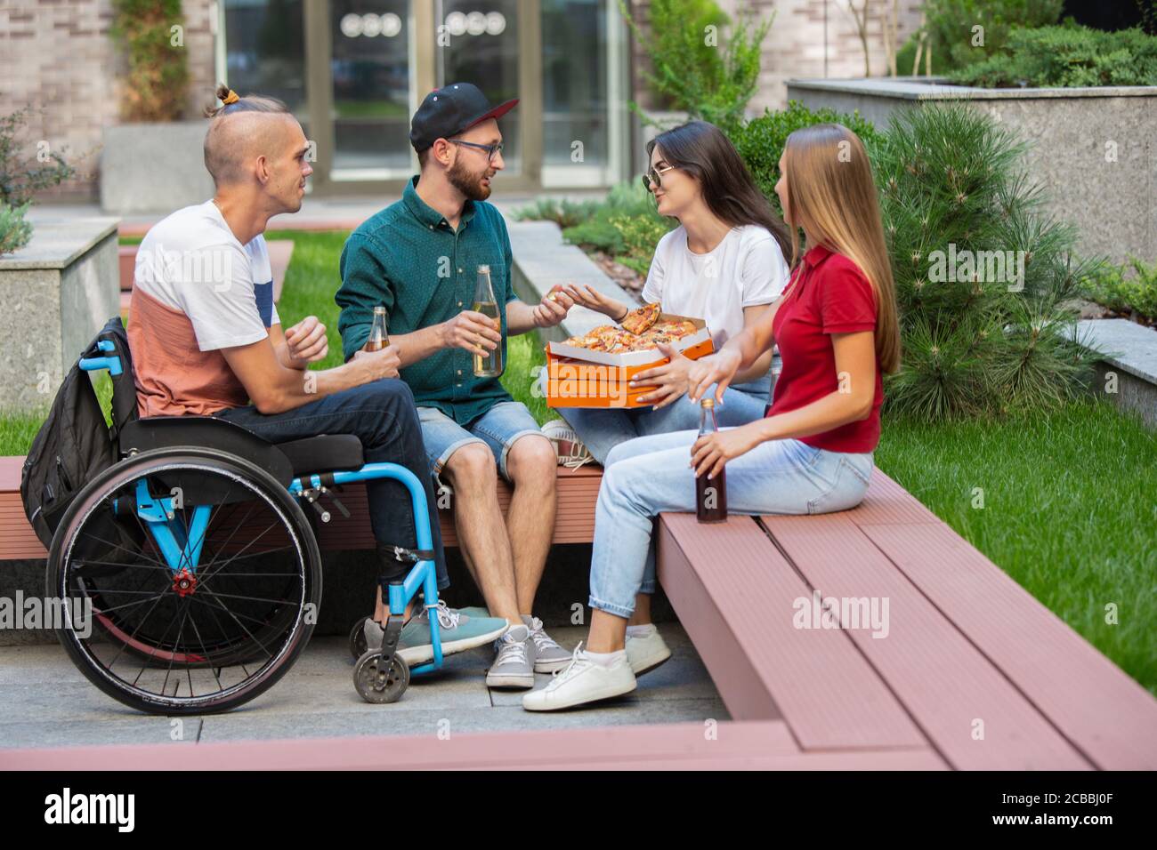 Together. Group of friends taking a stroll on city's street in summer ...