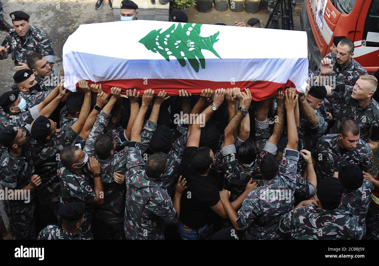 Beirut, Lebanon. 12th Aug, 2020. Firefighters carry the coffin of their ...