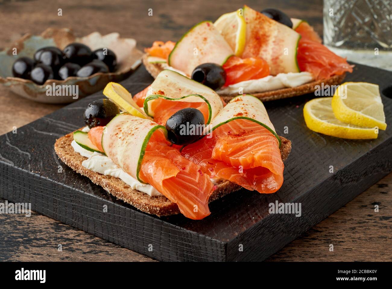 Smorrebrod - traditional Danish sandwiches. Black rye bread with salmon, cream cheese Stock ...