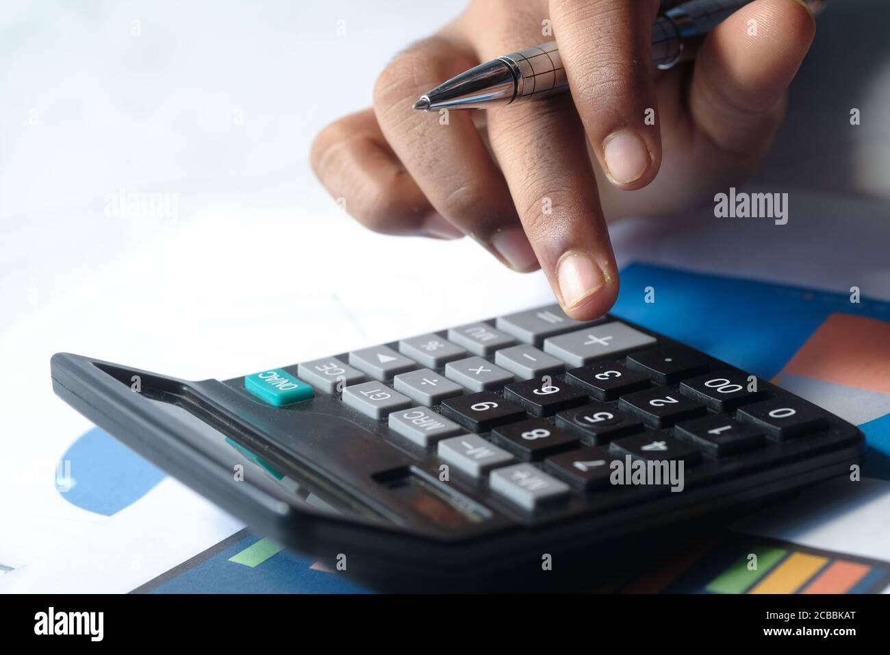 Close up of man hand using calculator Stock Photo - Alamy