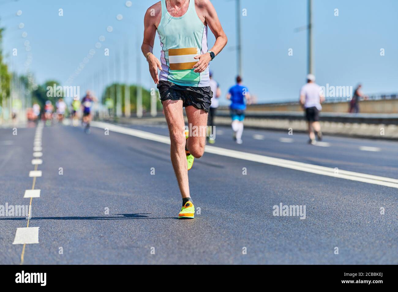 Running man. Athletic man jogging in sportswear on city road. Healthy ...