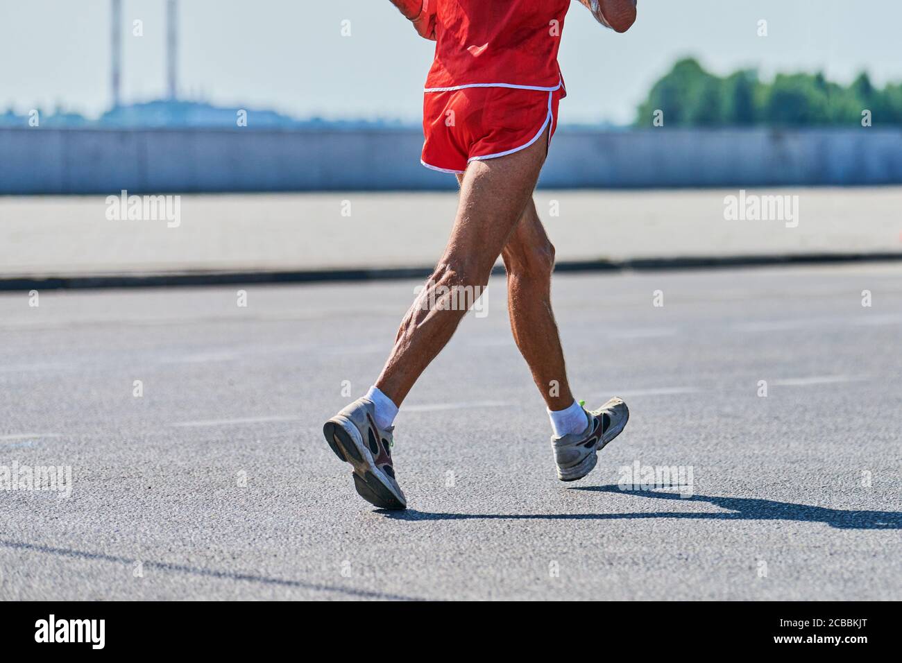 Running old man. Old man jogging in sportswear on city road. Healthy ...