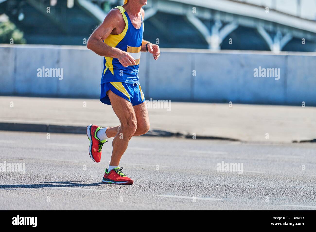 Running old man. Old man jogging in sportswear on city road. Healthy ...