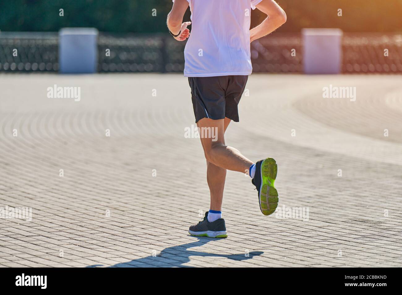 Running man. Athletic man jogging in sportswear on city road. Healthy lifestyle, fitness sport ...