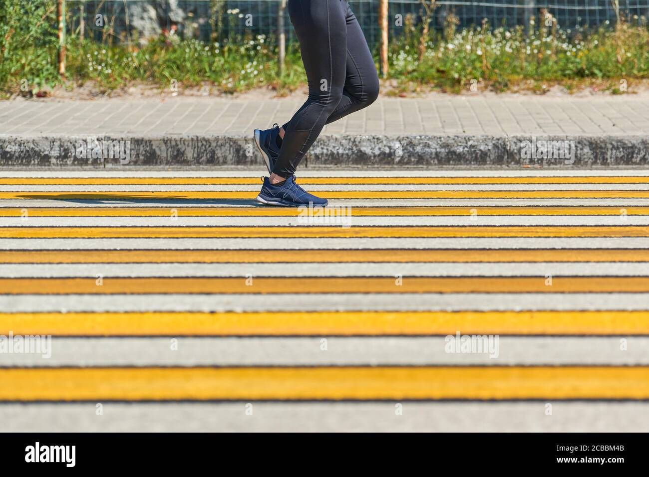 Woman running crosswalk, copy space. Athletic woman jogging in ...
