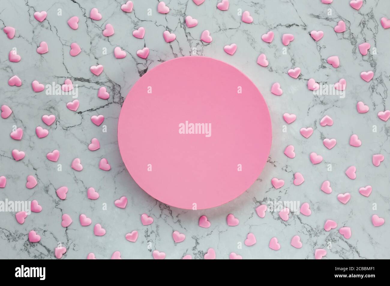 Pink round box on marble background with many tiny hearts Stock Photo ...