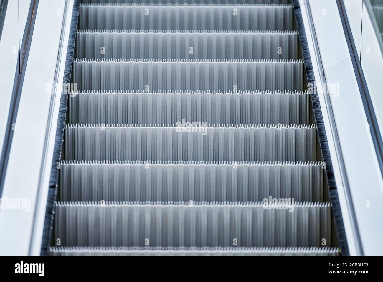 Escalator in shopping center. Close up escalators stairs up and down in ...