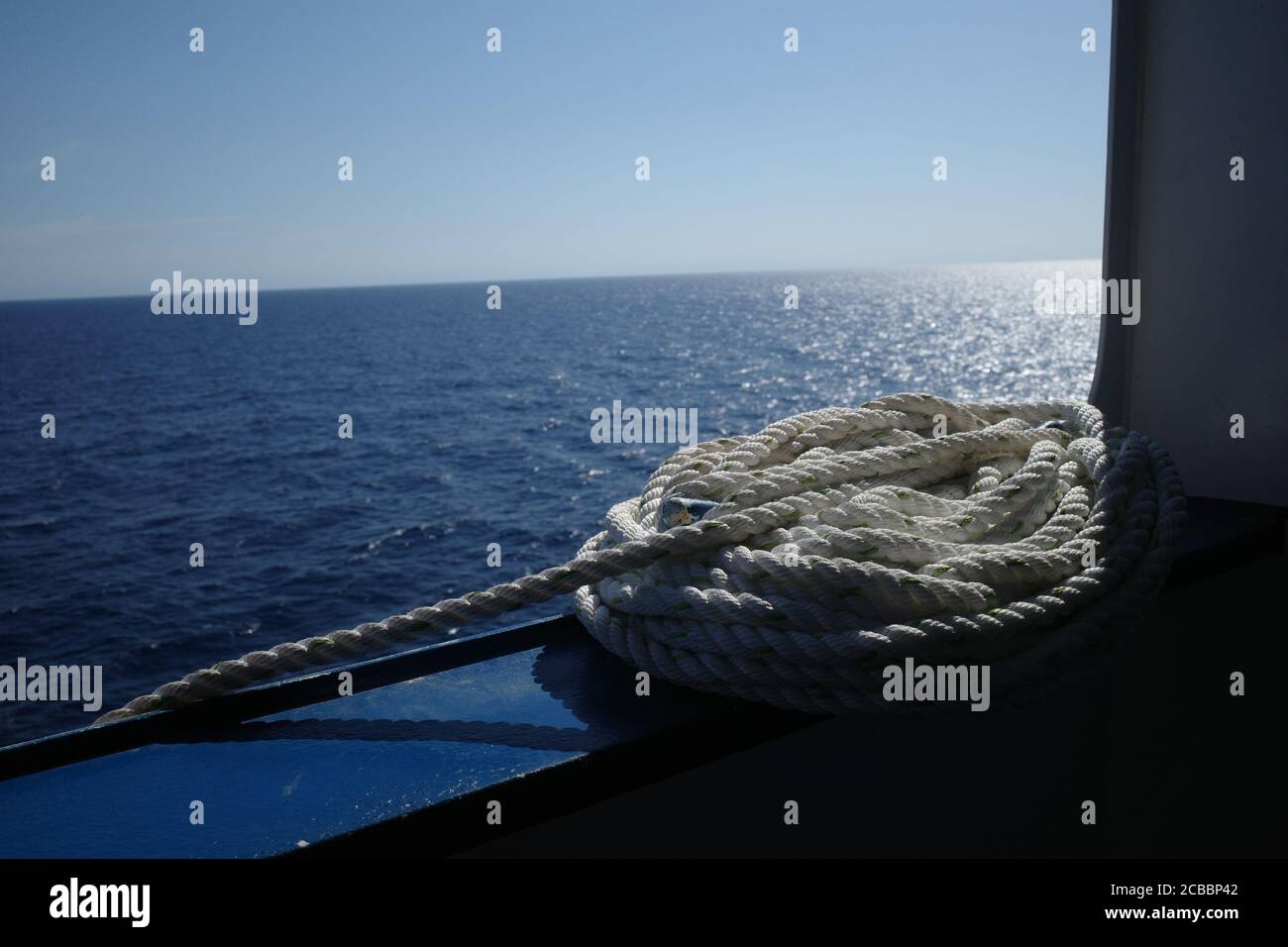 White rope on a boat with a blue sea on background Stock Photo - Alamy