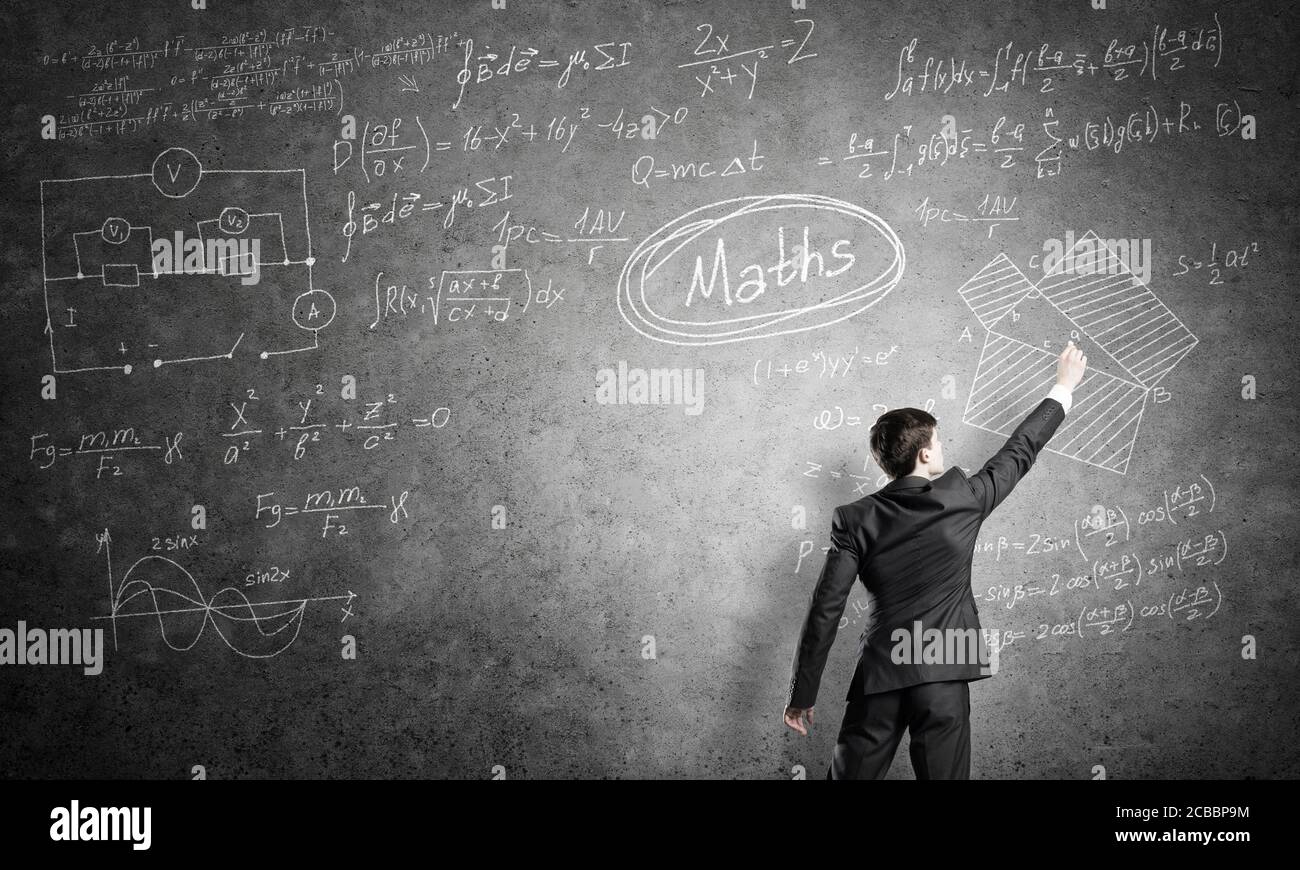 Man writing on blackboard Stock Photo - Alamy