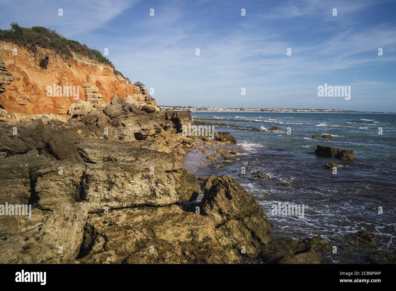 Landscape of the sea surrounded by cliffs and rocks at Chiclana beach ...