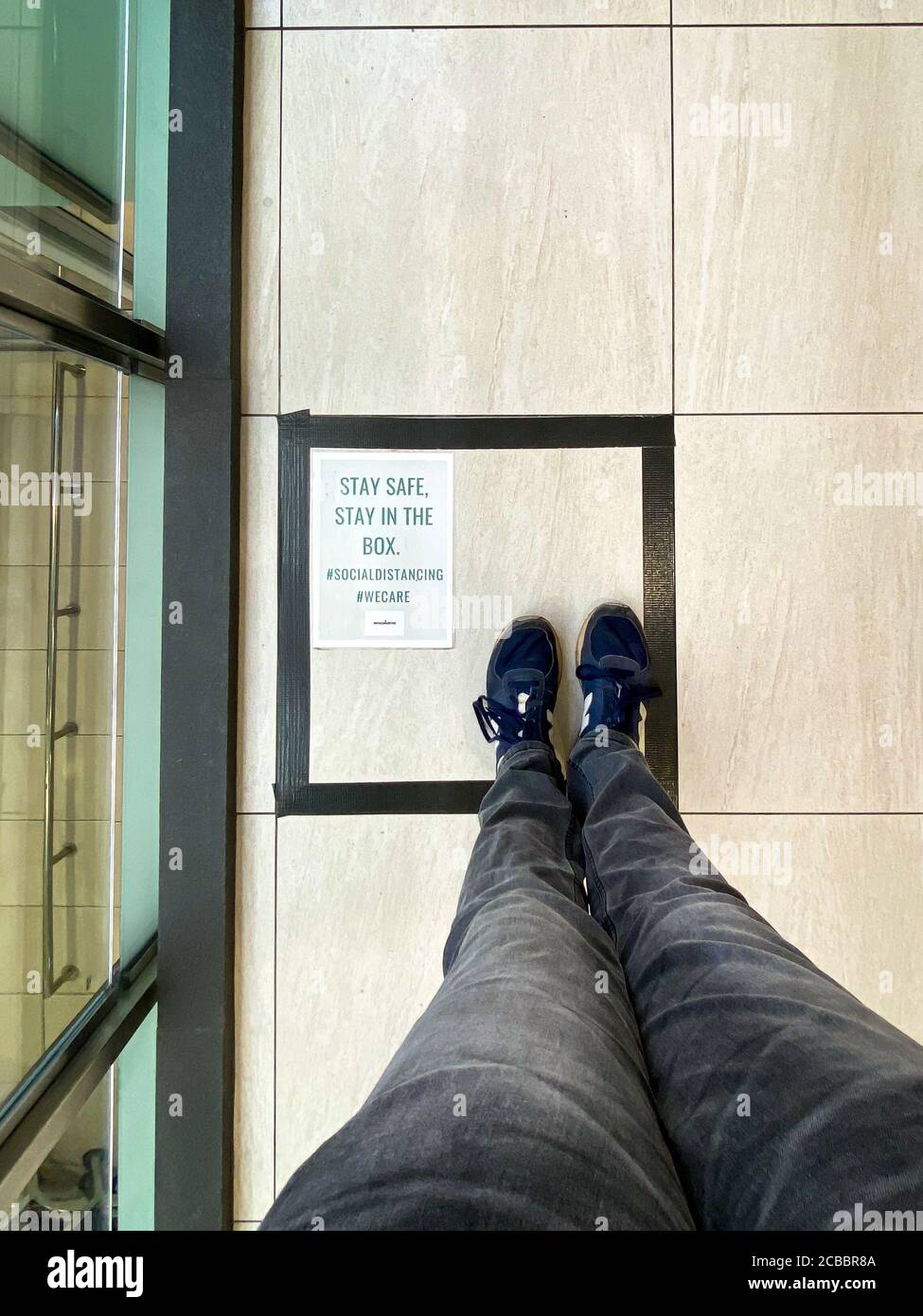 Required public social distancing taped square in a shopping mall ...