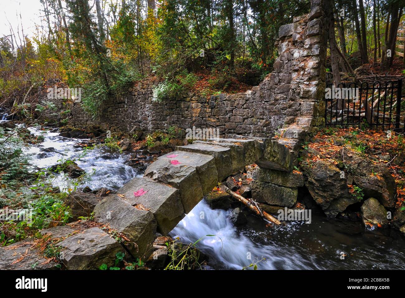 Old stone bridge over the river rapid Stock Photo - Alamy
