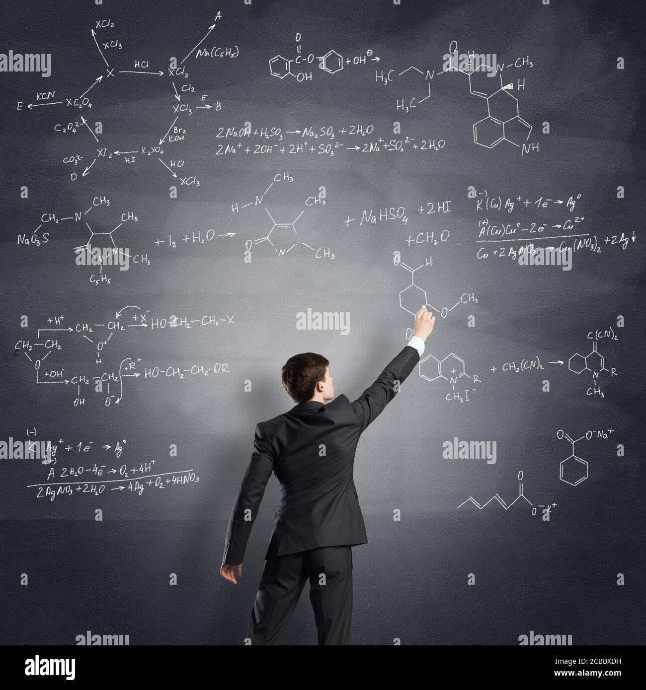 Scientist writing formulas on chalkboard Stock Photo - Alamy