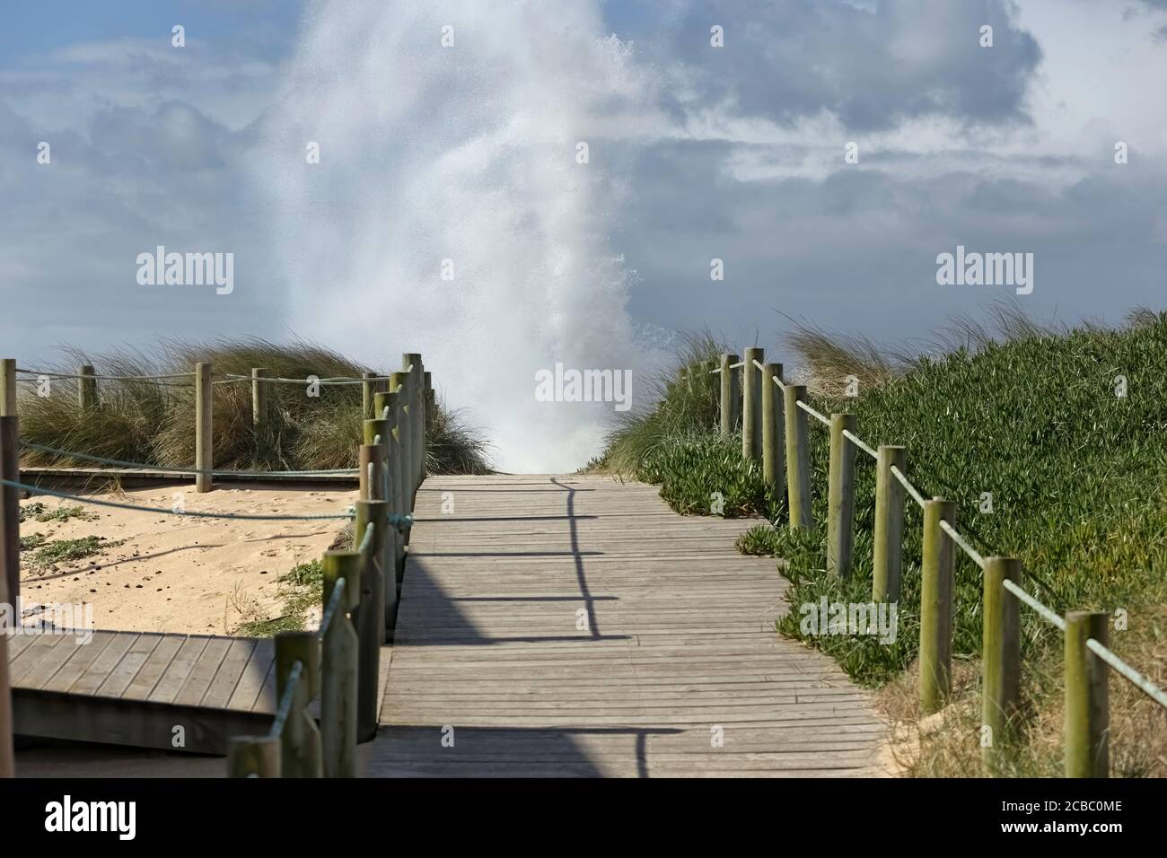 Sand dune walkway by the sea seeing wave splash. Northern portuguese ...