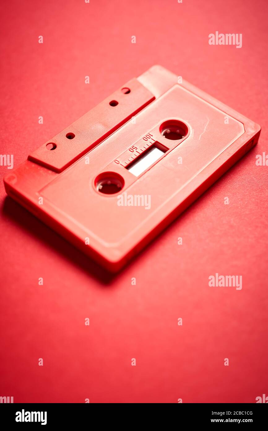 old red cassette tape on a minimalist background Stock Photo - Alamy