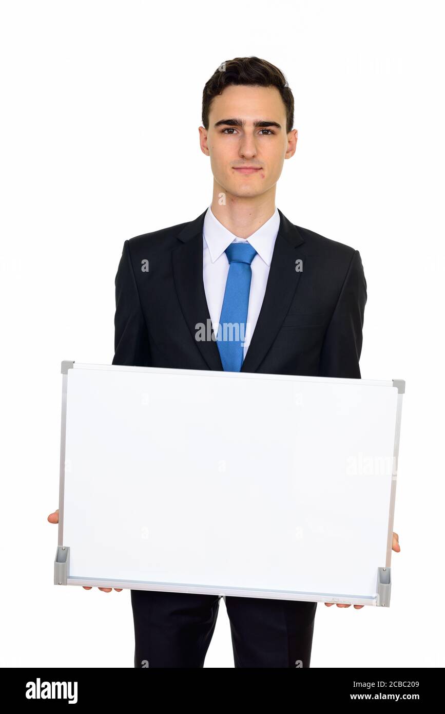 Studio shot of young handsome Caucasian businessman holding empty white ... Studio shot of young handsome Caucasian businessman holding empty white ...