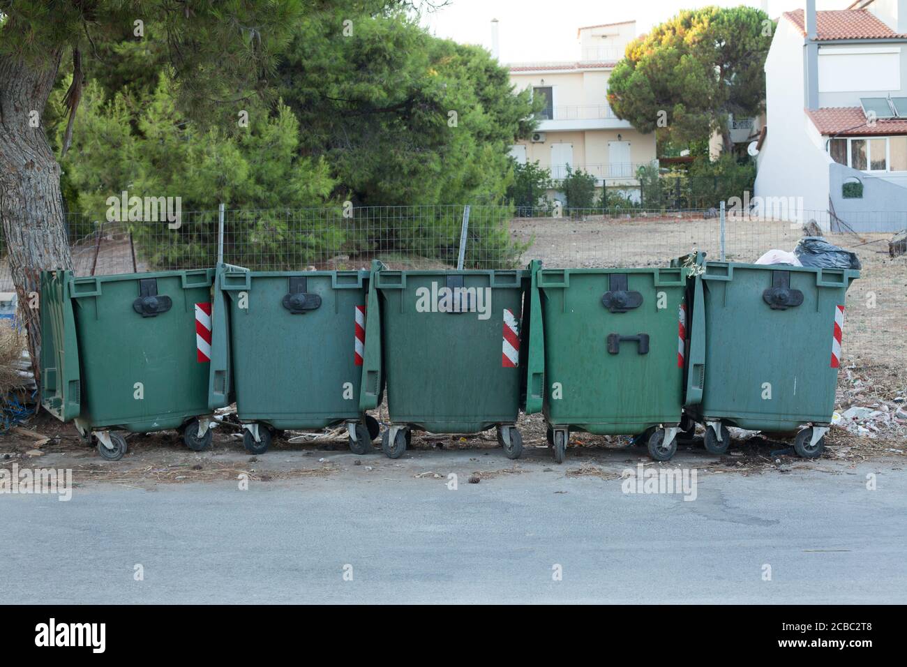 Garbage bins. Old green trash bins outdoors Stock Photo - Alamy