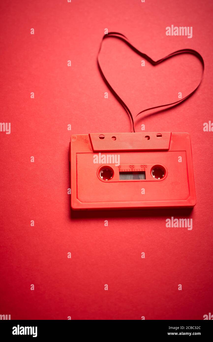 old red cassette tape on a minimalist background Stock Photo - Alamy