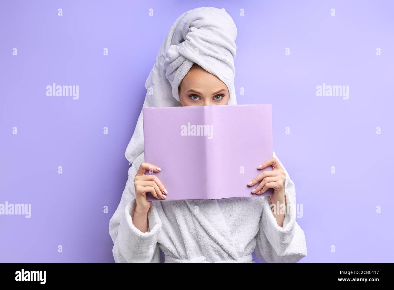 closed half of face of caucasian woman wearing bathrobe and towel after ...