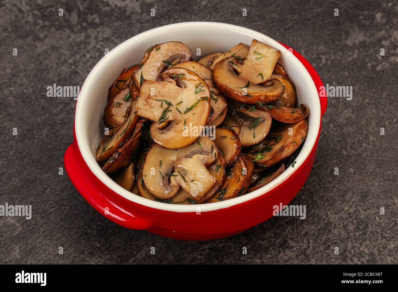 Roasted champignon with herbs and spices in the bowl Stock Photo - Alamy