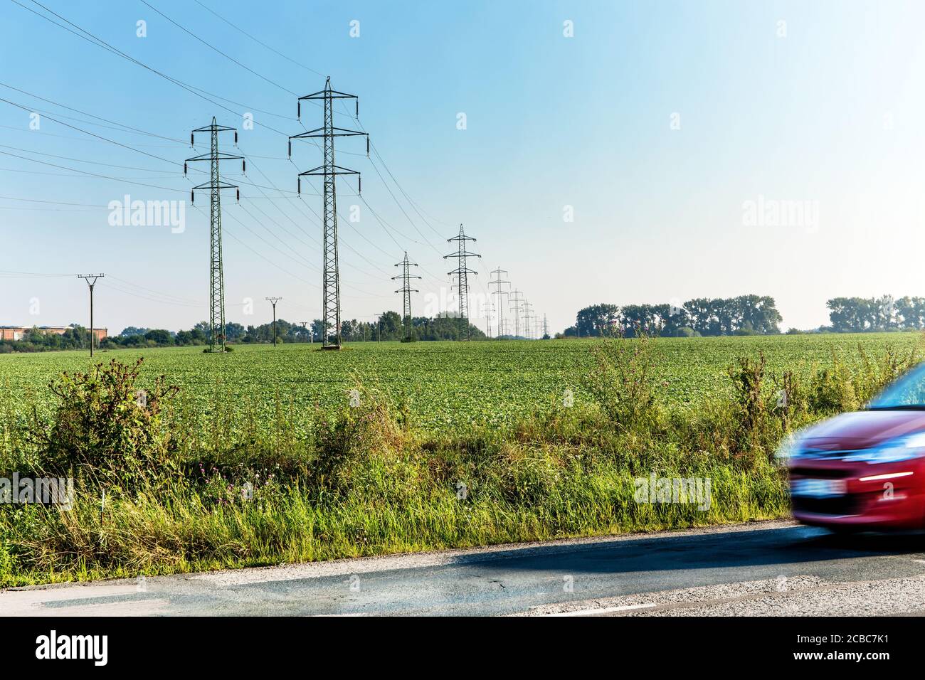 Power lines by the road. Energy concept. Electric car. High voltage ...