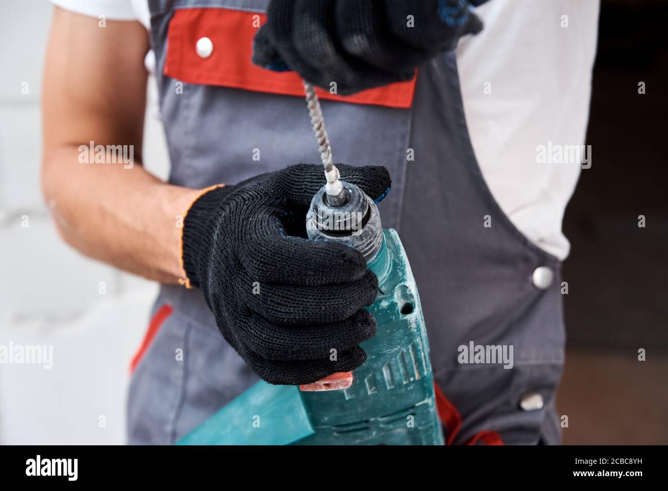 Man worker using hammer drill, close up Stock Photo - Alamy
