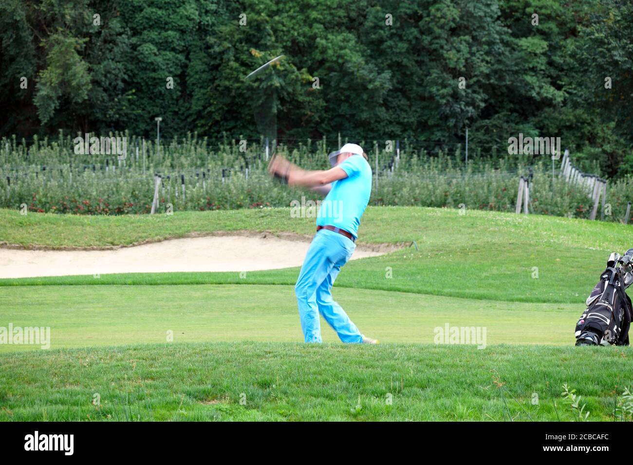 Blurred movement of a male golfer teeing-off at the Blue Monster golf ...