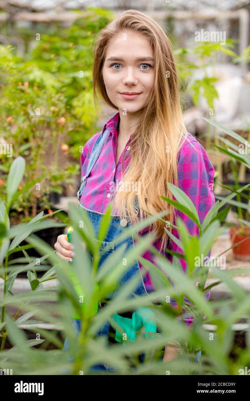 good looking girl with long fair hair in stylish casual clothes is ...