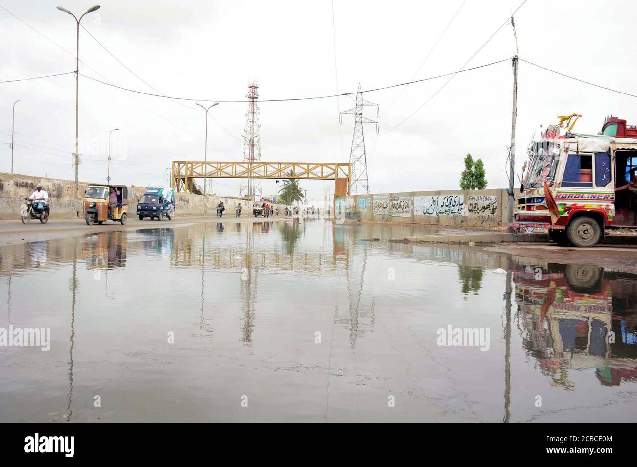 View of inundated road by stagnant rainwater caused by heavy downpour ...