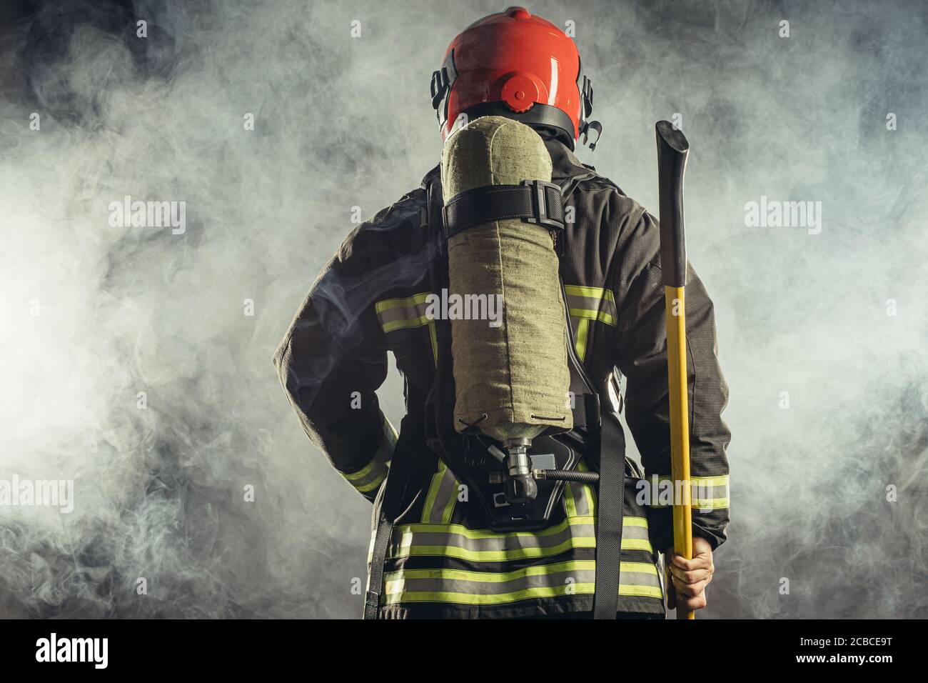 rear view on reverent, confident man working in fire station ready to ...