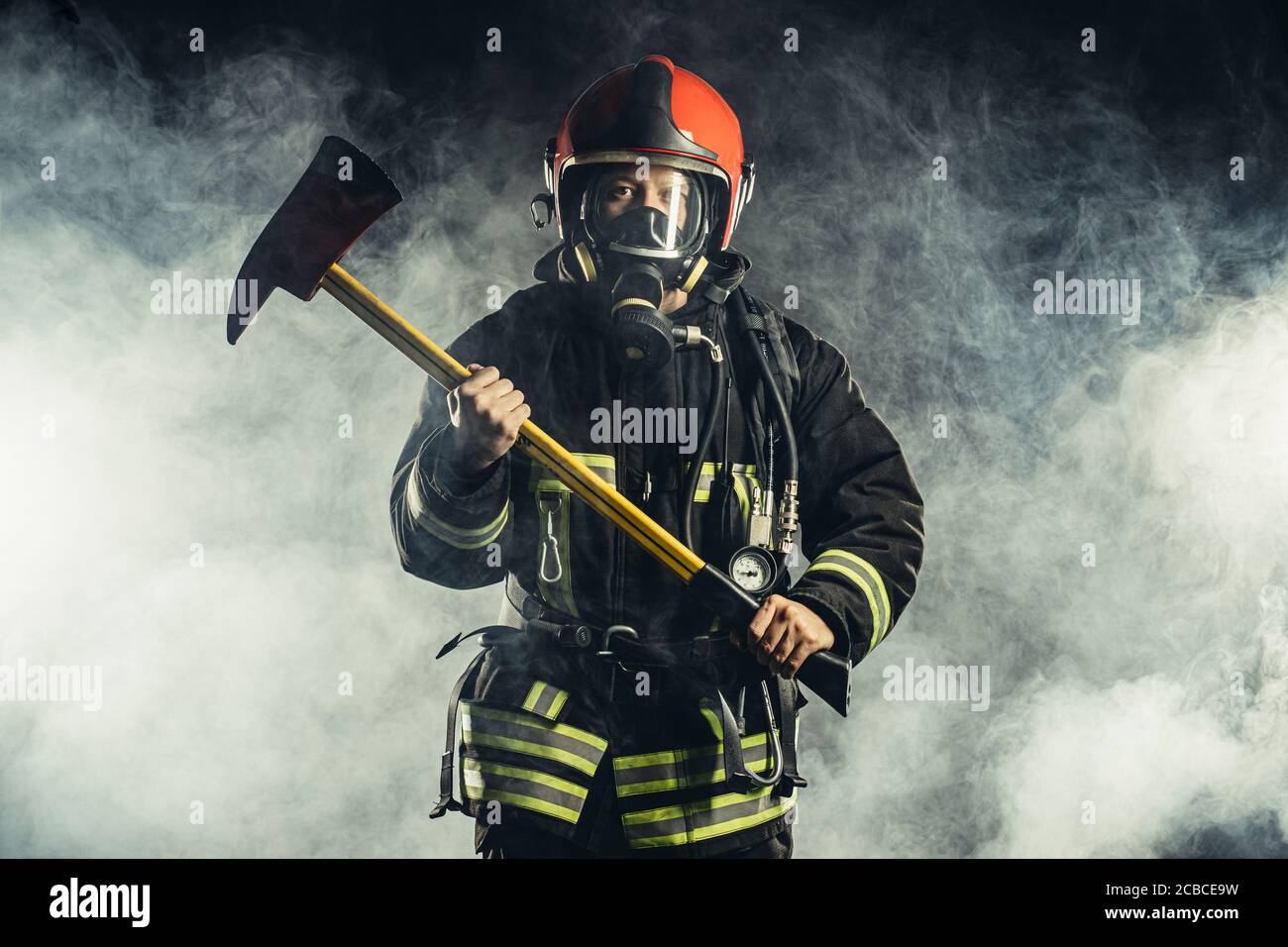young caucasian handsome and strong fireman in uniform wearing helmet ...