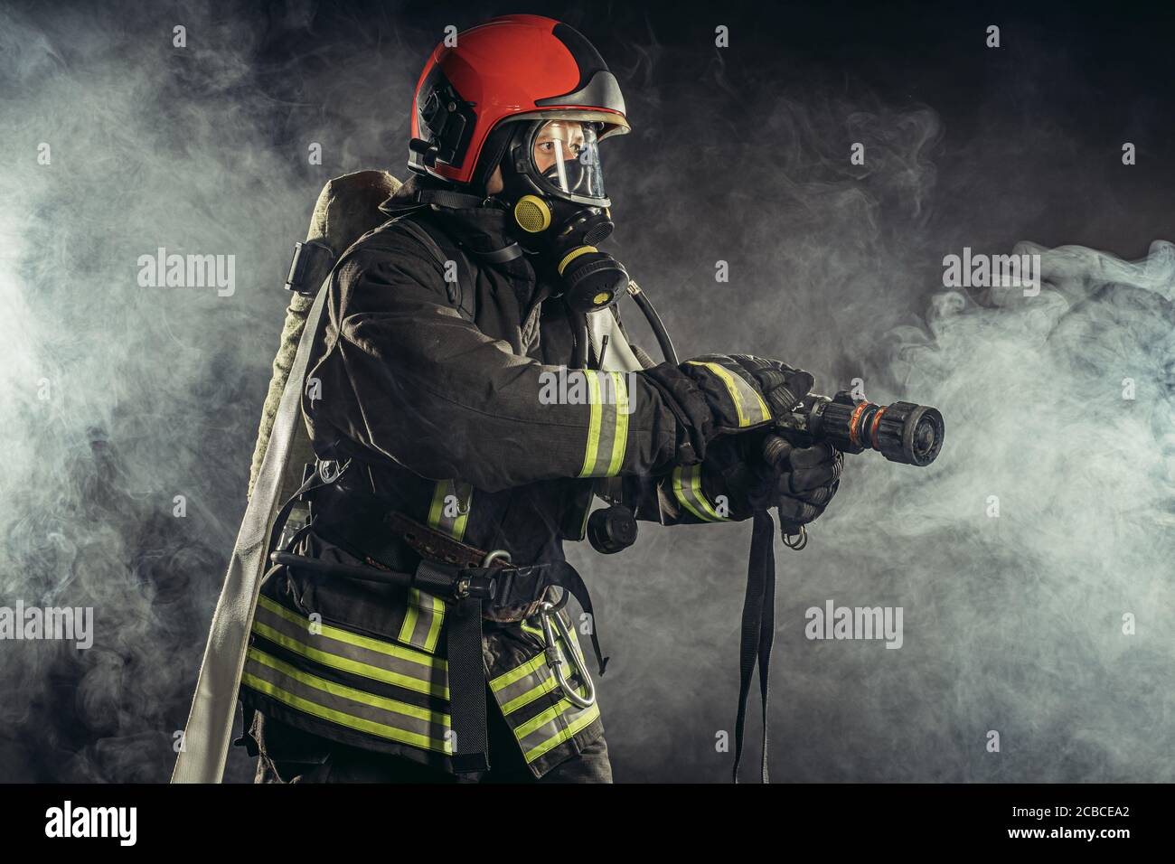 fireman or firefighter stand in smoke, professional worker of fire ...
