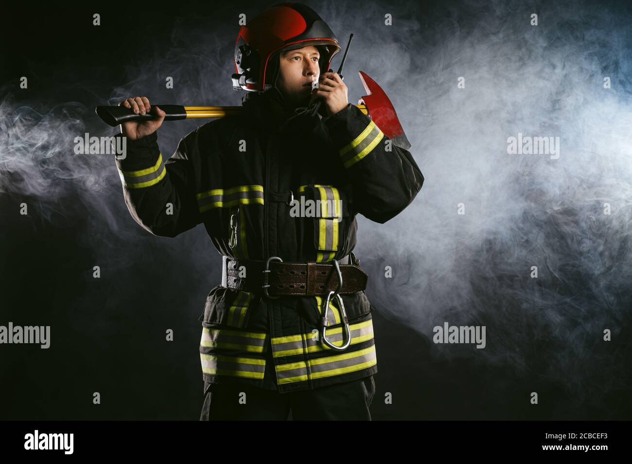 caucasian fireman using walkie talkie at work, reporting about ...