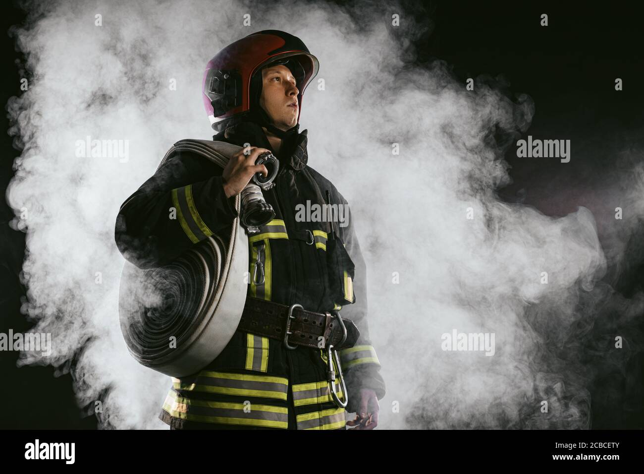 brave man fire fighter extinguishing fire, work at fire station and ...