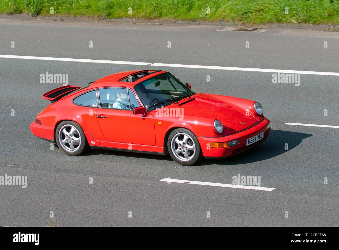 1990 90s nineties Red Porsche 911 Carrera; Vehicular traffic moving ...