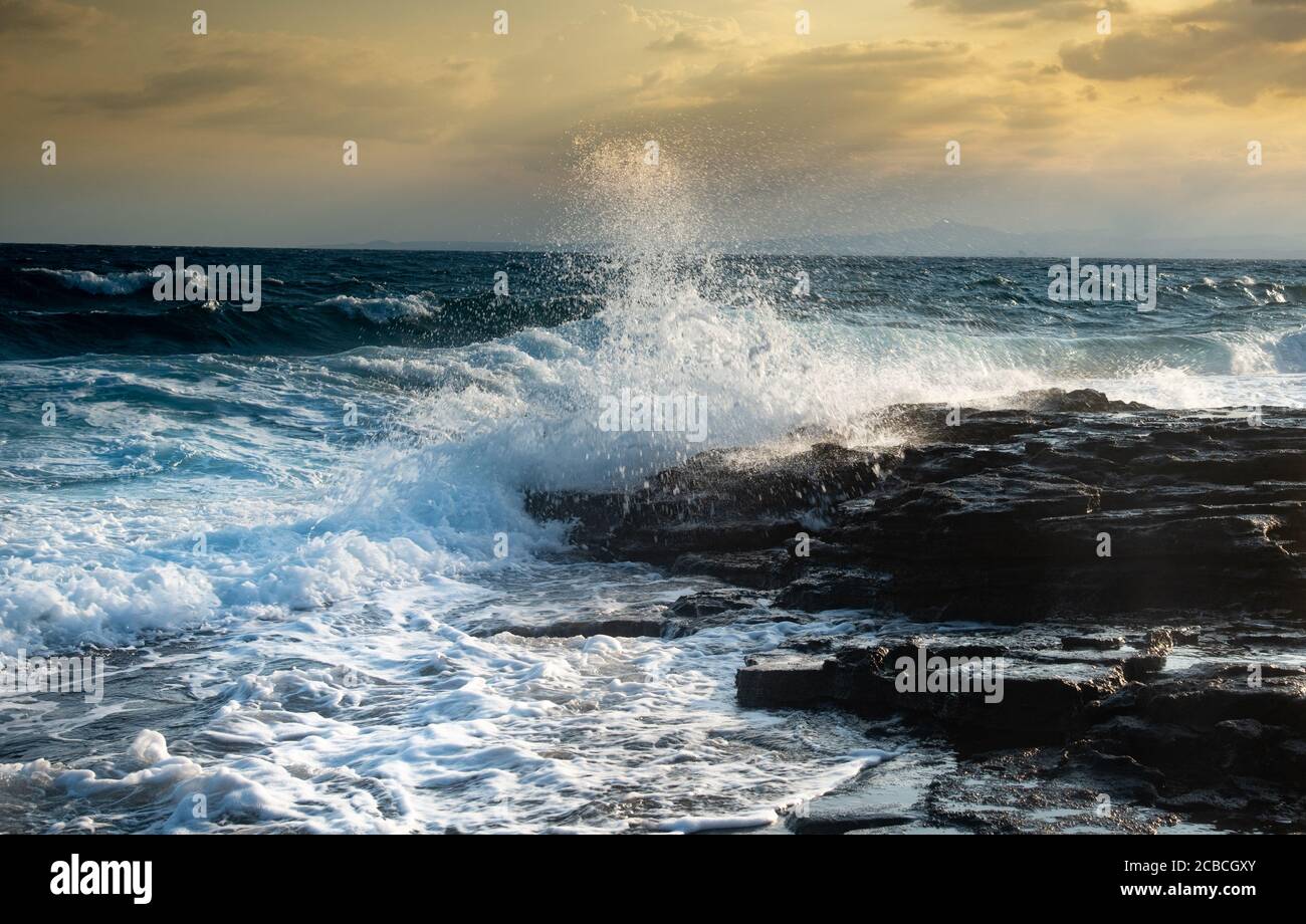 Splashing stormy windy sea waves on a rocky seashore Stock Photo - Alamy