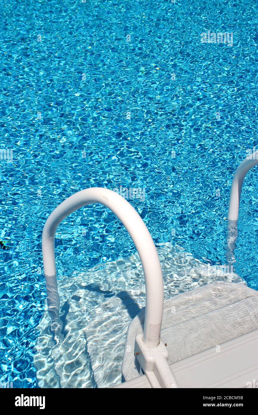 Pool steps leading into pool filled with water Stock Photo - Alamy