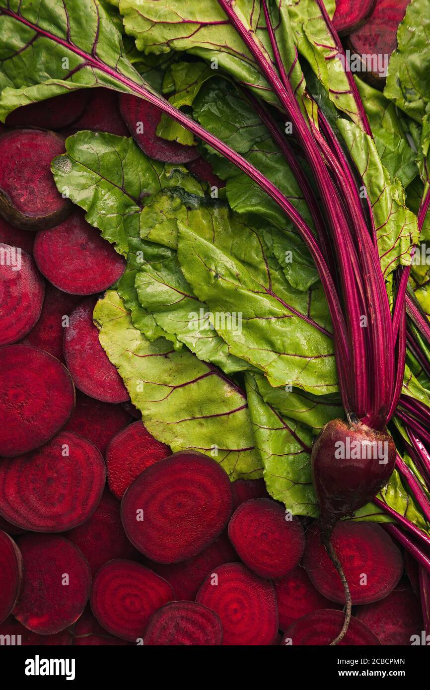 Top view of beet slices, beet leaves and one beet and beetroot for food ...