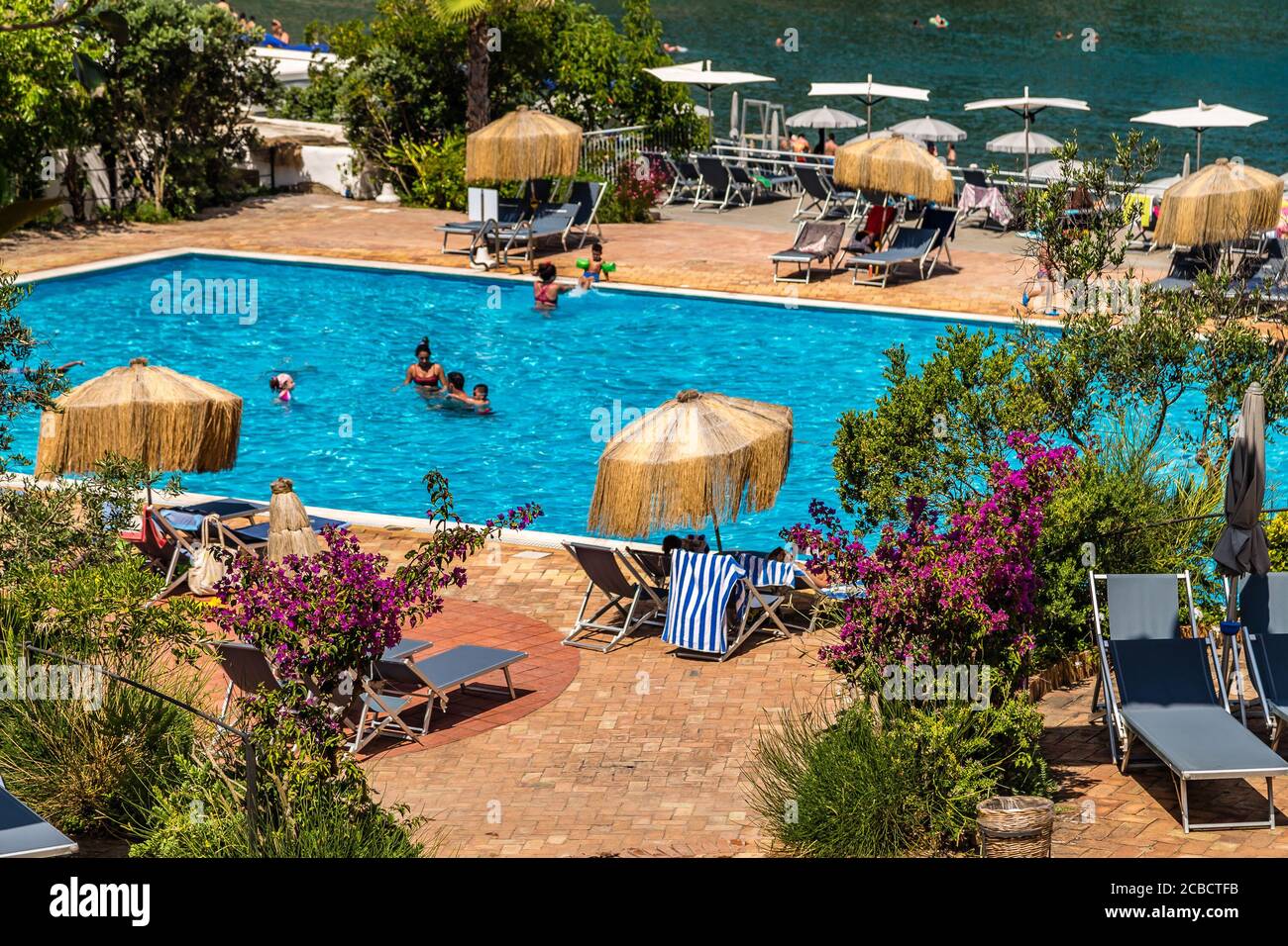 ISCHIA (NA), JUNE 29, 2020: tourists sunbathing and taking a swim in a ...