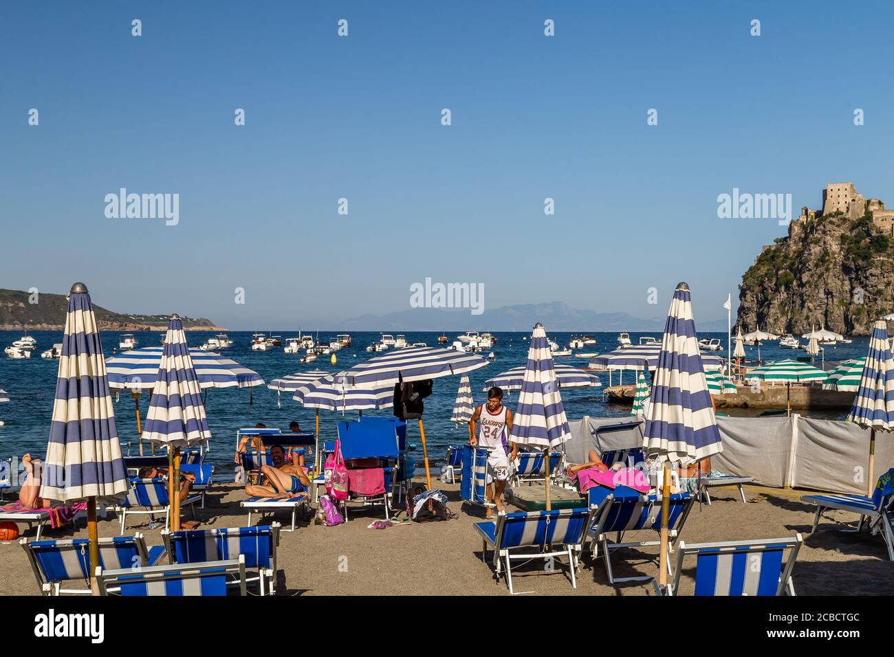 ISCHIA (NA), JUNE 29, 2020: tourists sunbathing and taking a swim in a ...
