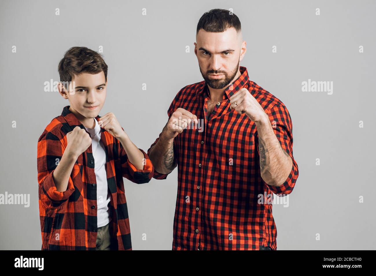 Dad and his son standing in boxing position. close up photo. isolated ...