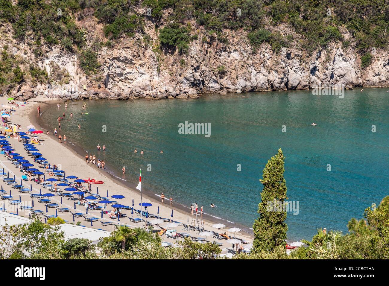 ISCHIA (NA), JUNE 29, 2020: tourists sunbathing and taking a swim in a ...