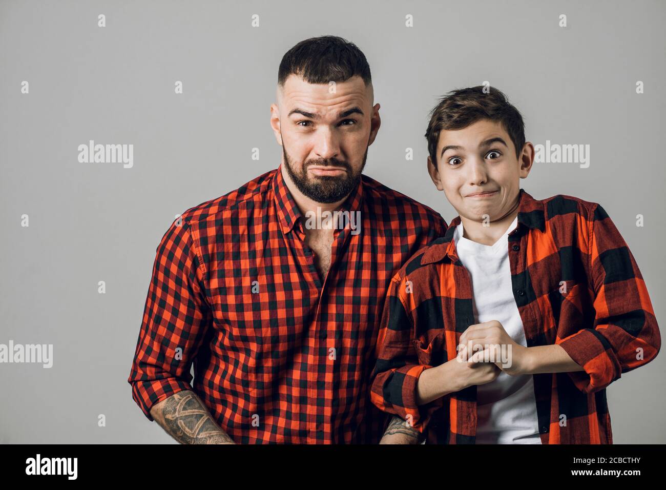 Surprised awesome scared dad and kid are watching TV. emotional family ...