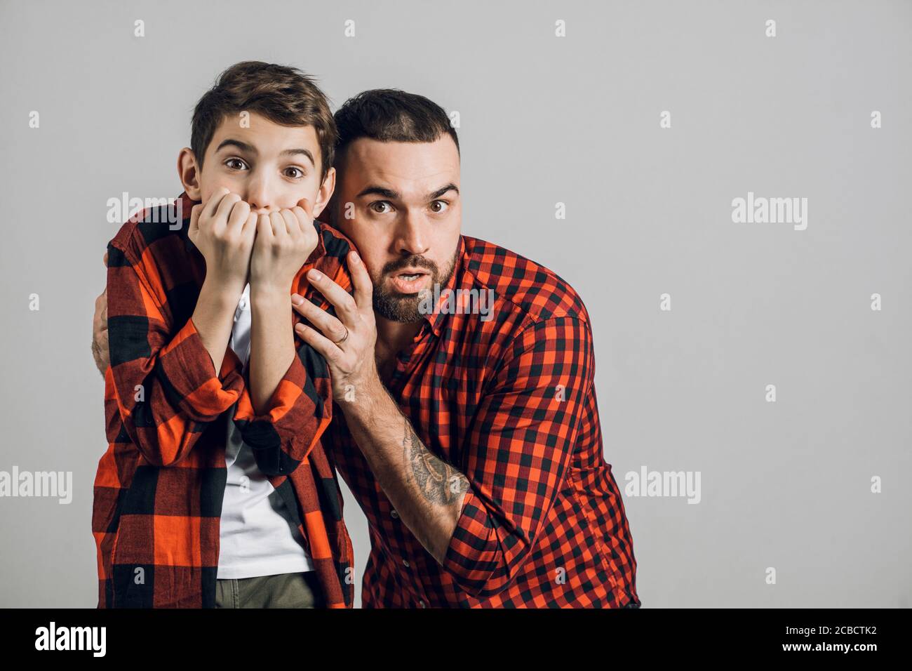emotional father and son looks with unexpected expression looking at ...