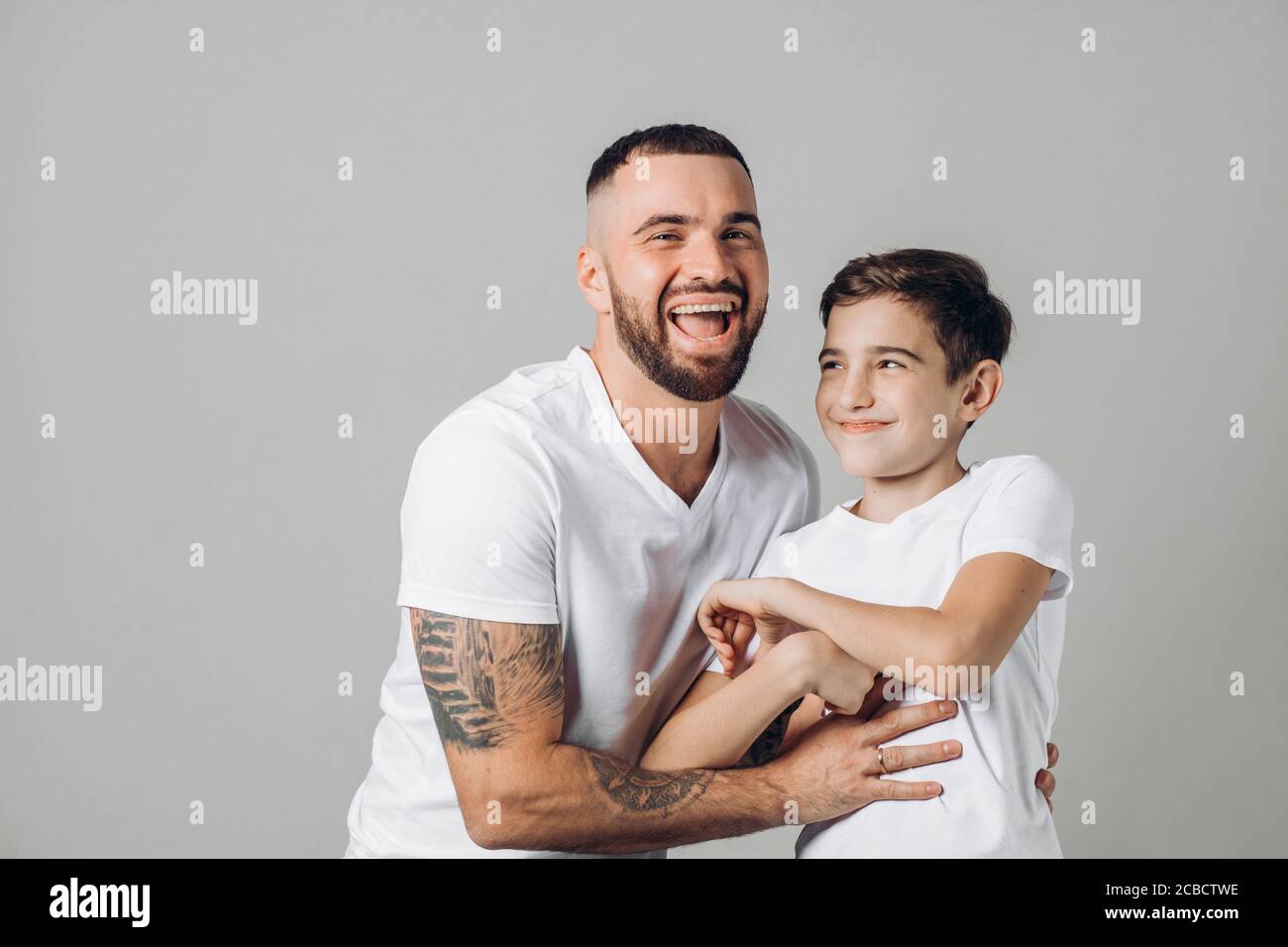 positive laughing daddy and son enjoy time. close up photo. happiness ...