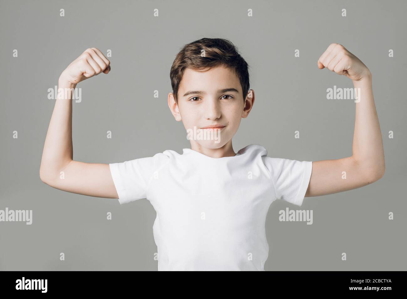 Flexing biceps boy hi-res stock photography and images - Alamy