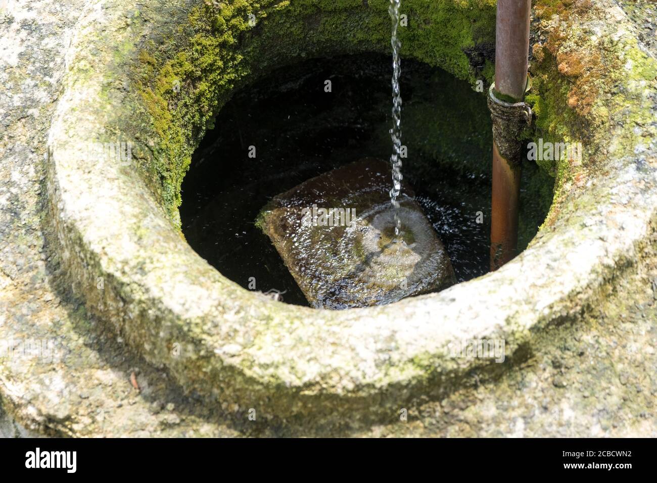 Very old fountain in which clean water flows. Located in the yard of a ...