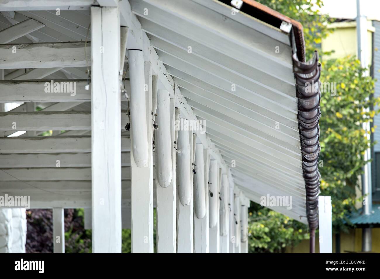 roof canopy of white wooden planks and supports with storm drains ...